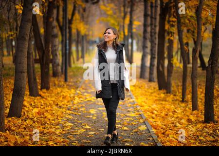 A woman walks by a fallen tree, in Bucharest, Romania, Wednesday July 1 ...