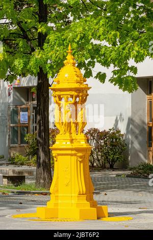 France, Paris, Wallace Fountain painted in yellow, Esplanade Pierre ...