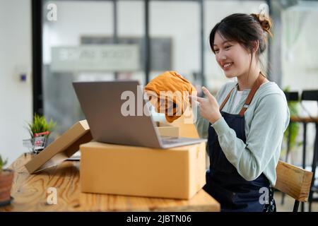 Happy young asian woman startup small business freelance with parcel ...