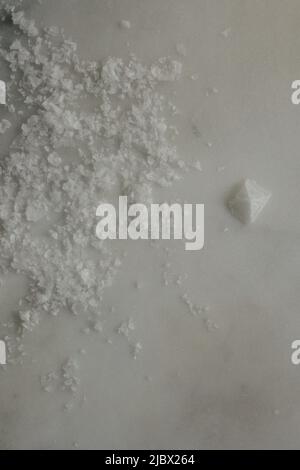 Maldon salt flakes with single pyramid shape salt crystal in center on ...