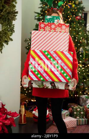 Young redhead woman holding gifts angry and mad screaming frustrated ...