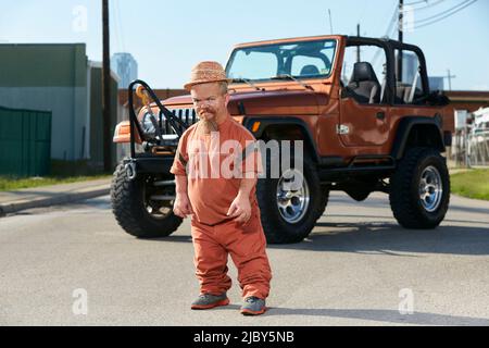 Portrait of male dwarf little person hugging his friend, standing in ...