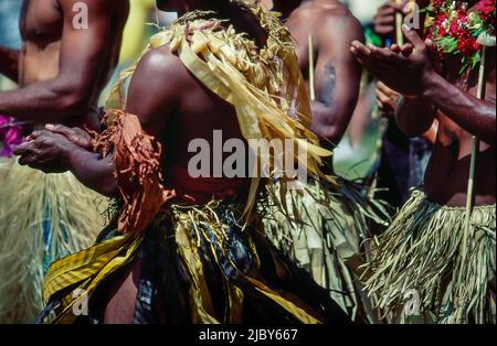 Native Fijian men dressed in traditional dress performing and dancing ...