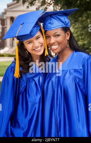 Portrait of two female graduates holding diplomas and smiling Stock ...