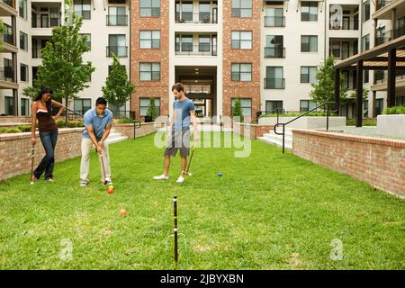 People playing croquet on lawn Stock Photo - Alamy
