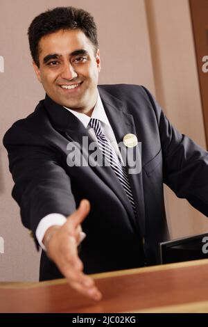 Businessman reaching out to shake the camera's hand Stock Photo - Alamy