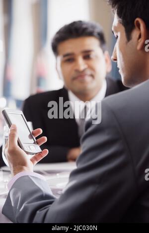 Businessman using a PDA in restaurant Stock Photo - Alamy