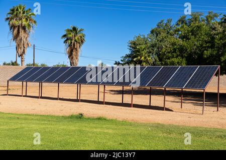 Solar power station in arid area under clear blue sky. Solar power ...