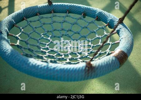 Round swings for children. Swings on ropes. Details of playground Stock ...
