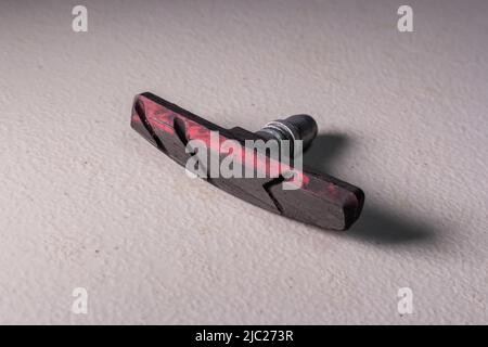 An old brake shoe for bicycle on a table in the dark mood. A brake in ...