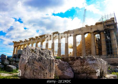 Fallen columns in front of the Parthenon on the Athens Greece Acropolis with scaffolding and a ...