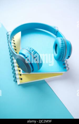 Audio book concept. Headphones and notepad on table Stock Photo - Alamy