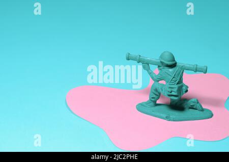 A small, pink plastic toy weapon isolated on a white background Stock ...
