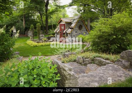 Reading pavilion in landscaped residential backyard garden in summer ...
