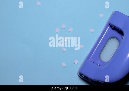 Blue Hole punch or Perforate machine on sky blue background Stock Photo ...