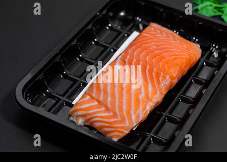 Salmon run stock on plastic packaging with food absorbent in ...
