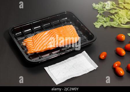 Salmon run stock on plastic packaging with food absorbent in ...