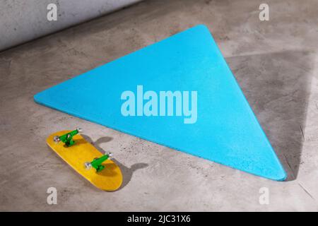 Blue plaster ramp and yellow fingerboard on abstract background Stock ...