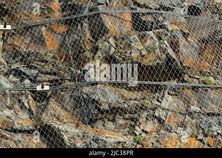 detail of a mesh rockfall barrier draped along Stock Photo - Alamy