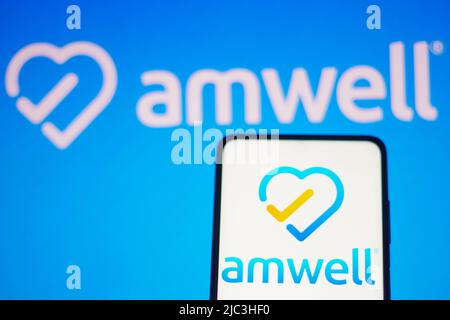 In this photo illustration, the Amwell logo seen displayed on a ...