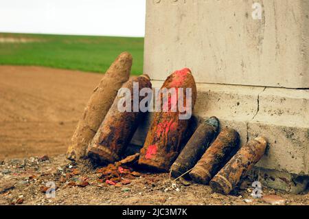 First World War artillery shells and poppies by the roadside near ...