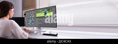 Professional female film editor editing video on his personal computer ...