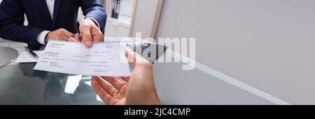 Businessman's Hand Giving Cheque Stock Photo - Alamy