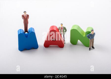 Tiny figurine of men beside colorful wooden letters say MAN Stock Photo ...