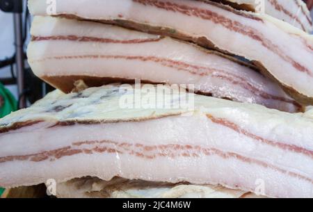 Iberian salt-cured pork fat. Pieces displayed at street market stall ...