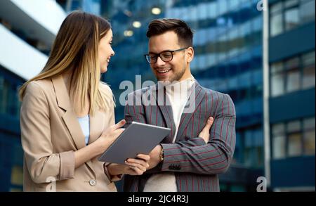 Two desingers, business people working on a project together in urban ...