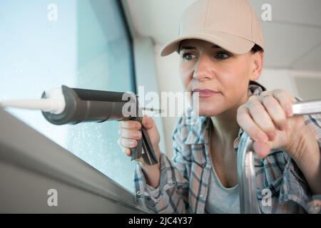 woman window installer Stock Photo - Alamy