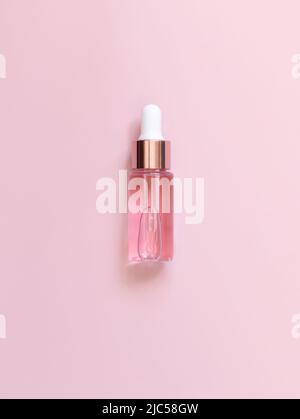 Dropper bottle on a light pink background Stock Photo - Alamy