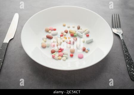 Close up of pills on plate. Dietary supplements. Variety pills. Vitamin ...