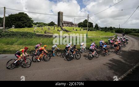The peloton goes through the village of Llangynderyrn during stage five ...