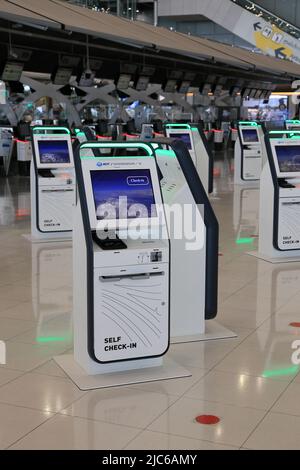 Self service machine desk kiosk at airport for check in printing boarding pass and buying ticket ...