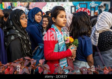 A crowd marches through the street to commemorate the sacrifices of the ...