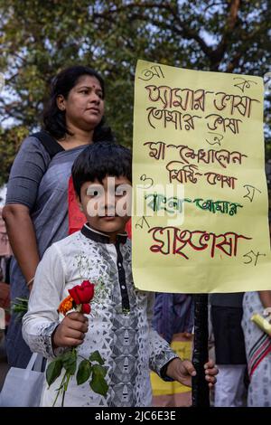 A crowd marches through the street to commemorate the sacrifices of the ...