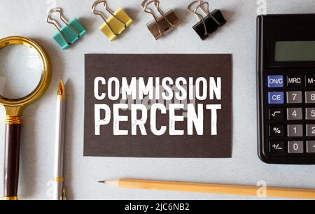 The word commission written on white paper sheet with hundred dollar ...