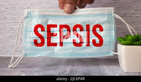 Doctor holding a card with text Sepsis, medical concept Stock Photo - Alamy