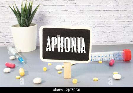 Paper with text APHONIA on table with stethoscope Stock Photo - Alamy