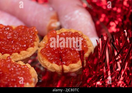 Salmon caviar in a tartlet on a glass dish. Festive table setting Stock ...