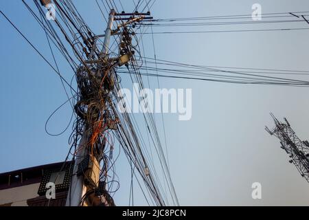 Electricity poles with overcrowded wires and distribution boxes in ...