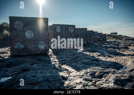 WWII anti tank defense. Blocks of concrete lining the beach head on the ...