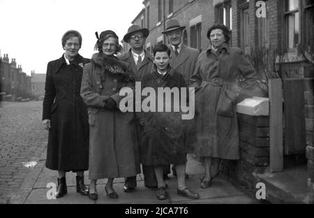 1950s, historical, a family photo, standing outside on grass in the ...