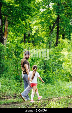 Adorable girl having fun in greenhouse. Portrait of kid with basket ...