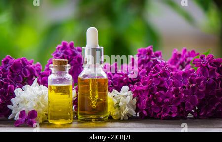 Lilac essential oil in a small bottle. Selective focus. Nature Stock ...