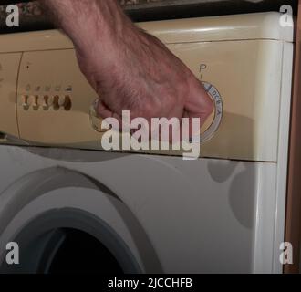 a woman starting washing machine Stock Photo - Alamy