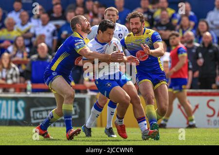 Toby King of Warrington Wolves is tackled during the Betfred Challenge ...