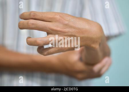 Fingers rigidity, Hand muscles spasm, or Weakness of digits. Closeup ...