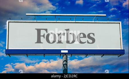 Advertisement billboard displaying logo of Forbes Stock Photo - Alamy